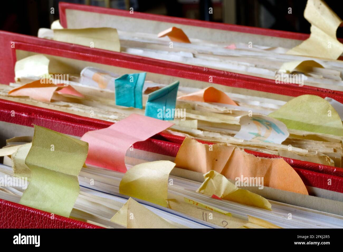 messy file folders and documents, close-up, slective focus, red tape ...