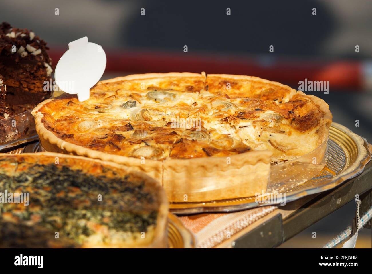 Quiche, displayed pastry at farmers street food market, plain labels ...