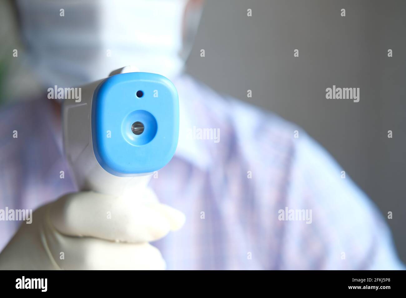 Hand holding infrared thermometer to measuring temperature Stock Photo ...