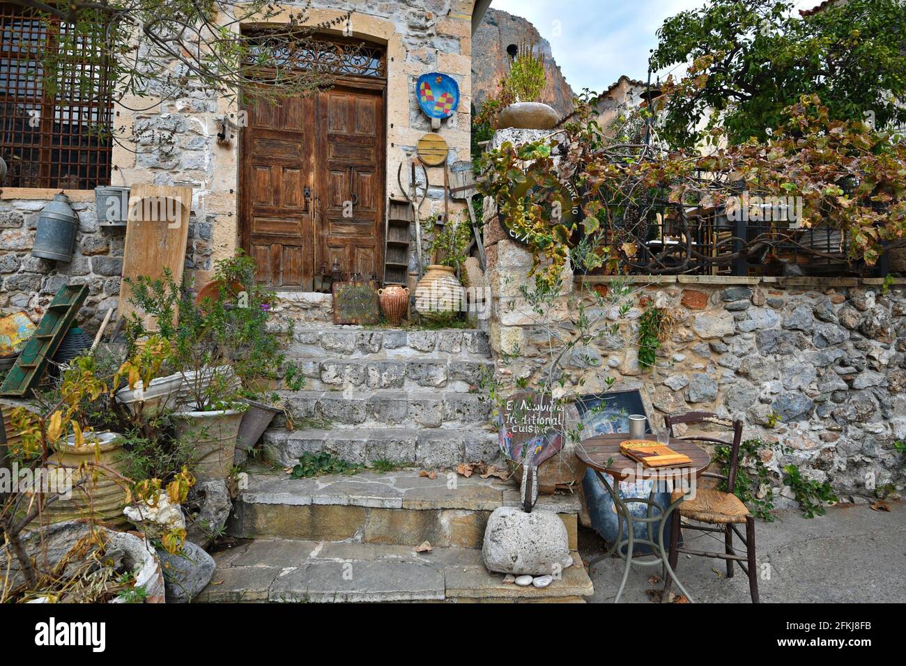 Traditional old Greek taverna and antique shop facade with a ...