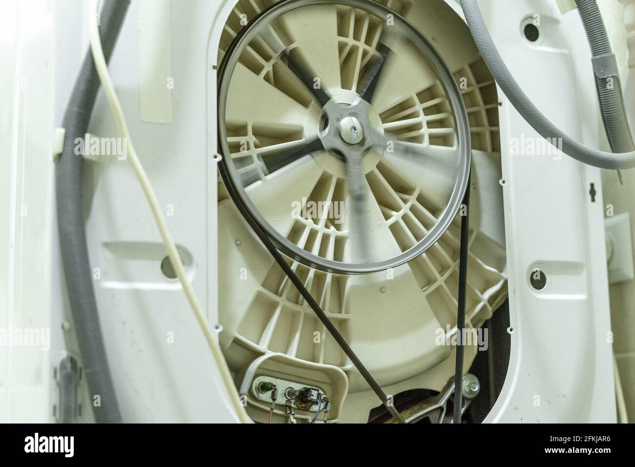 The pulley of the washing machine on the drum at high speeds during ...