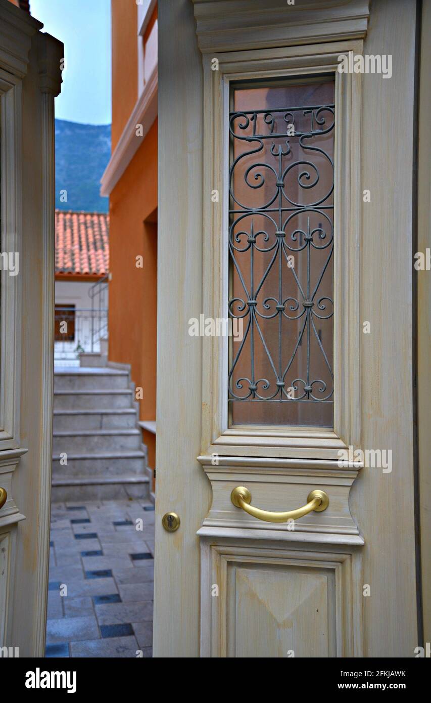 Neoclassical style entrance door with a brass handle in Leonidio ...