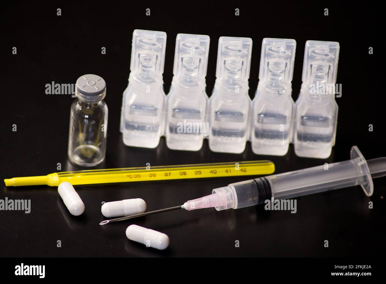 Medicine and drug concept. Medical ampoules, syringe and injection on ...