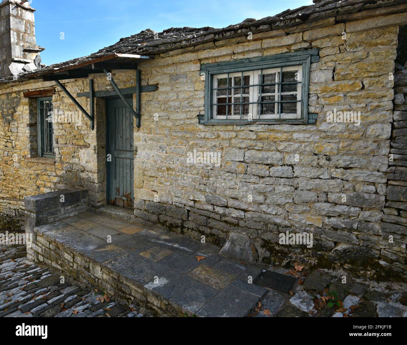 Traditional stone built house with a slate rooftop in Vitsa, a historic ...