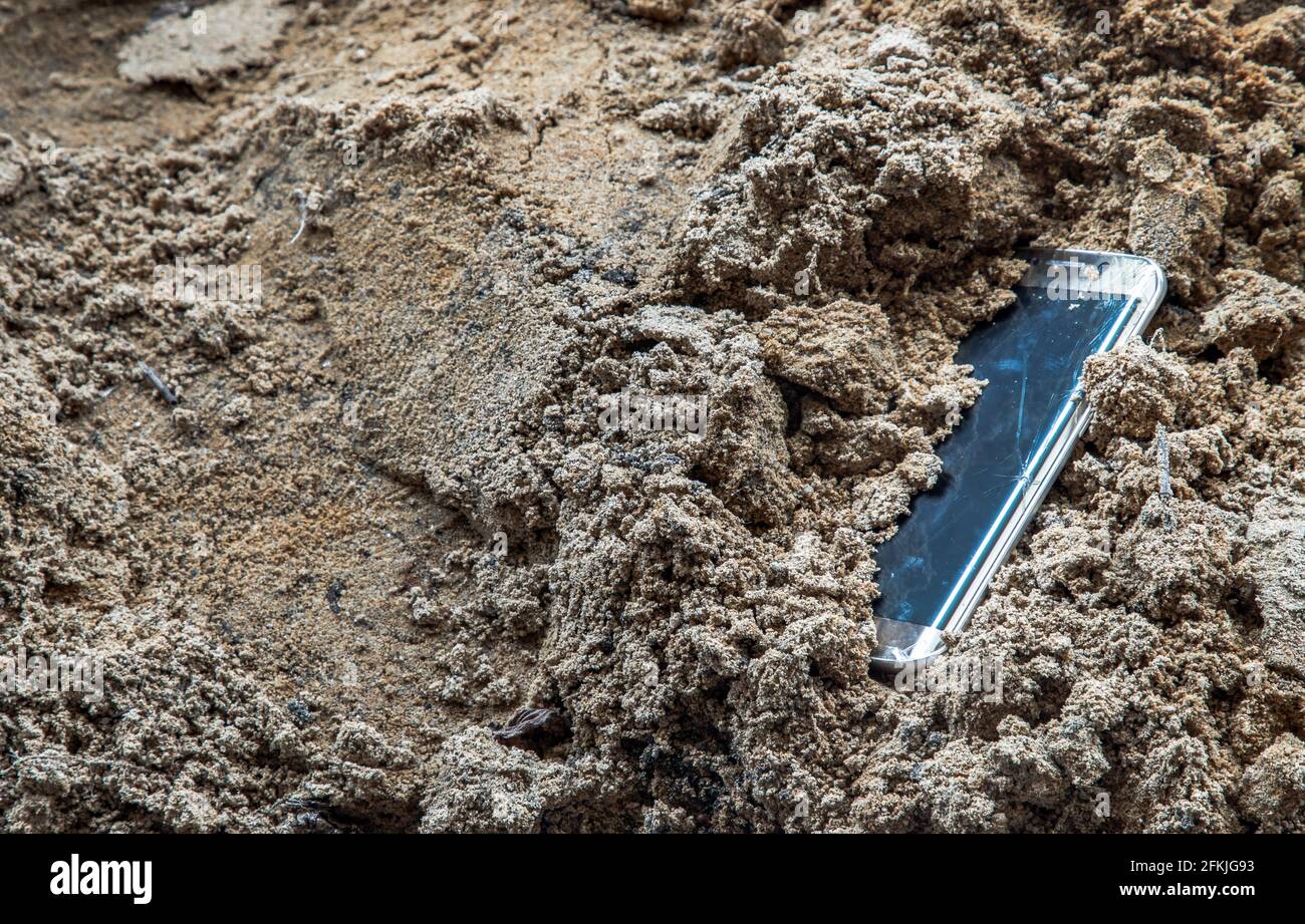 The remains of mobile phones with a broken screen that are garbage ...
