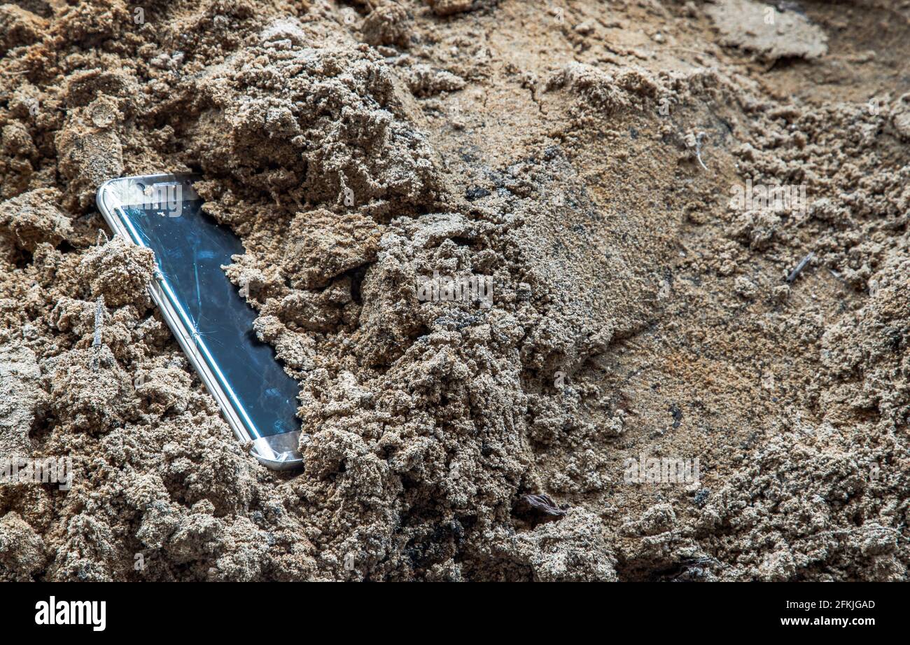 The remains of mobile phones with a broken screen that are garbage ...