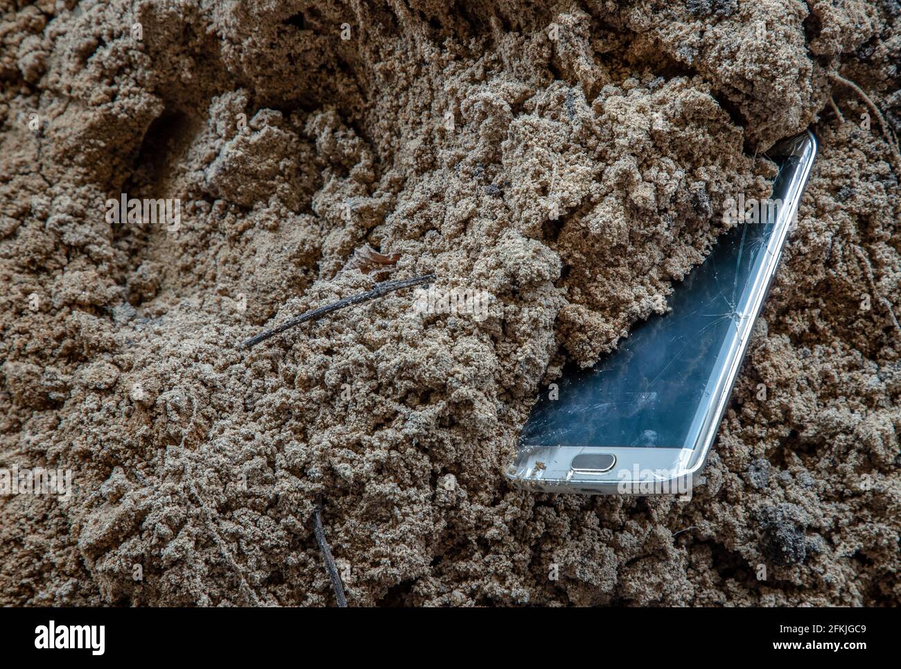 The remains of mobile phones with a broken screen that are garbage ...