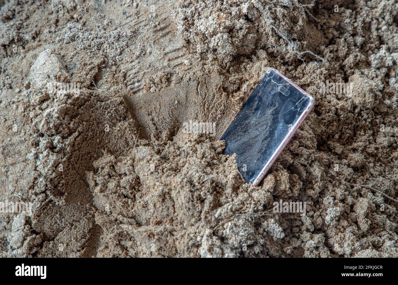 The remains of mobile phones with a broken screen that are garbage ...