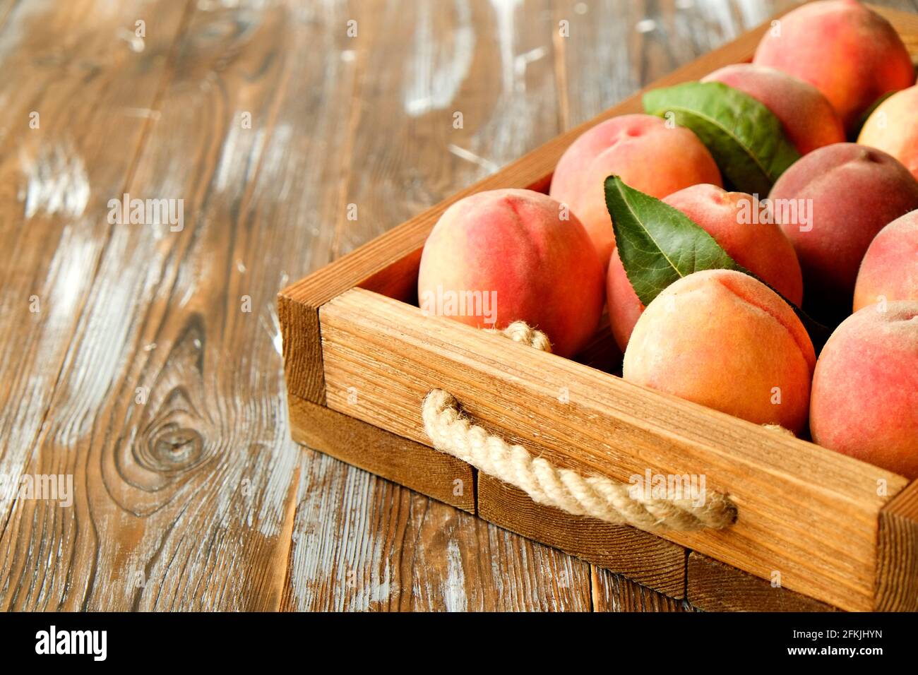 Peaches with leaves on tray hi-res stock photography and images - Alamy