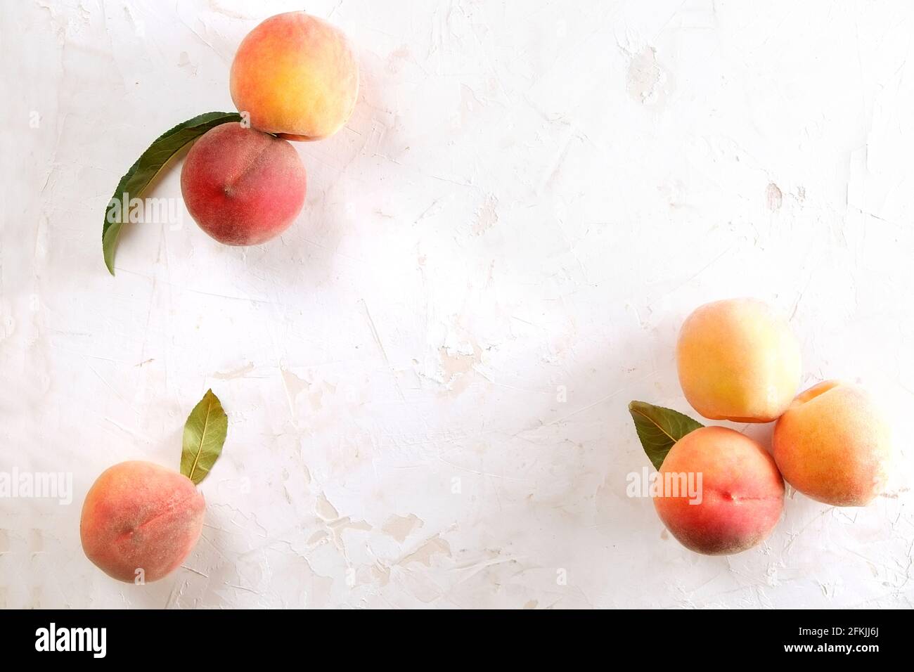 Bunch of ripe organic peaches in pile on wooden tray tray with rope ...