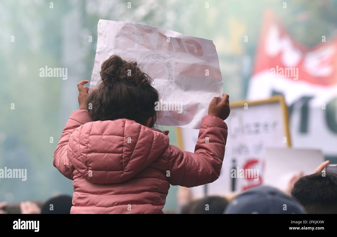 A young fan holds up a sign during a fan protest against the club ...