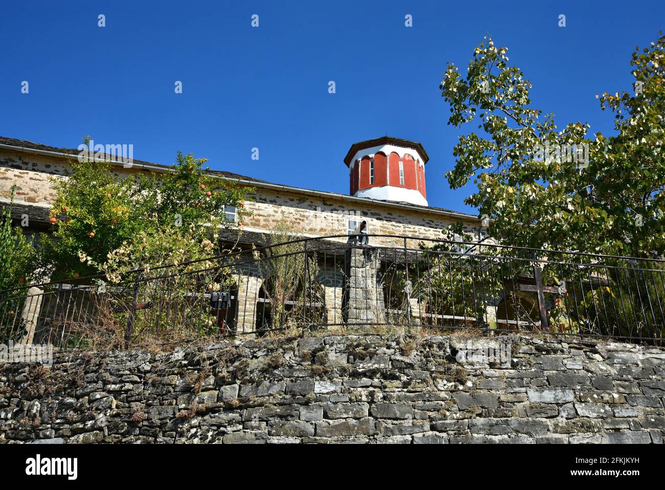 Ancient stone built Greek Orthodox church with red dome in Doliani, a ...