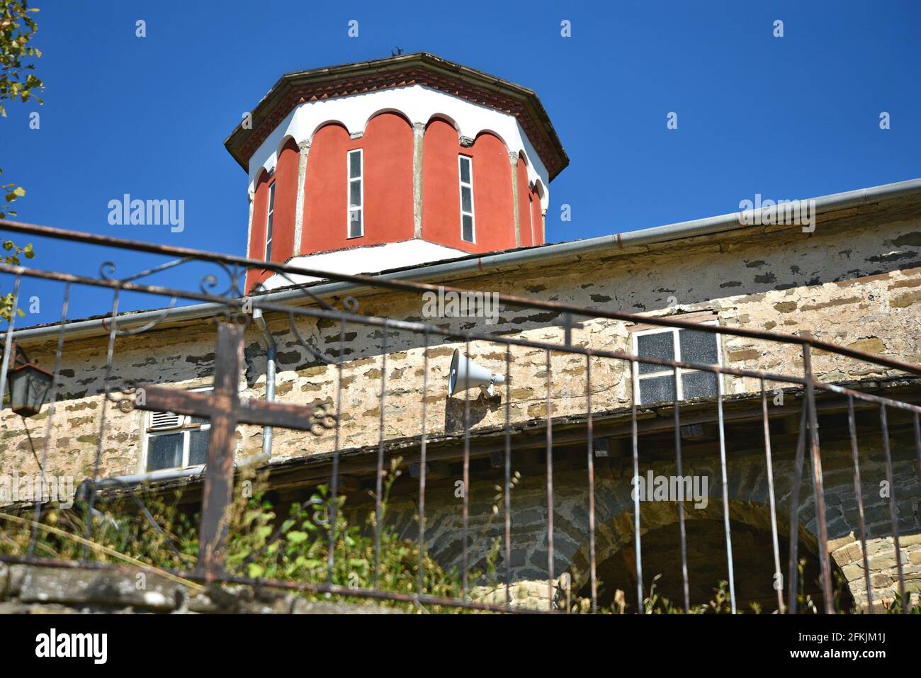 Ancient stone built Greek Orthodox church with red dome in Doliani, a ...