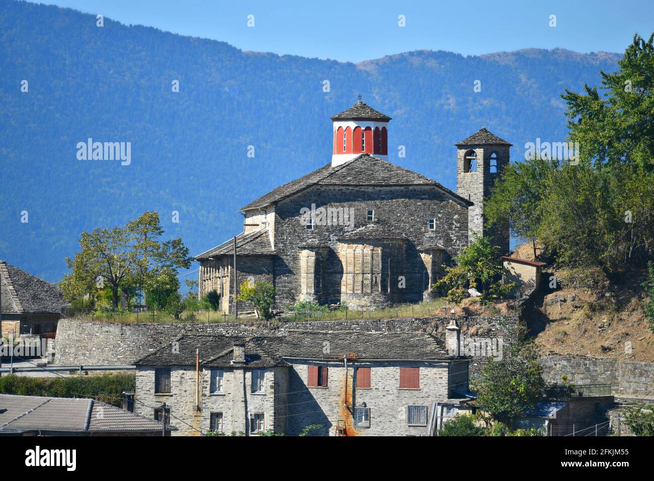 Ancient stone built Greek Orthodox church with red dome in Doliani, a ...