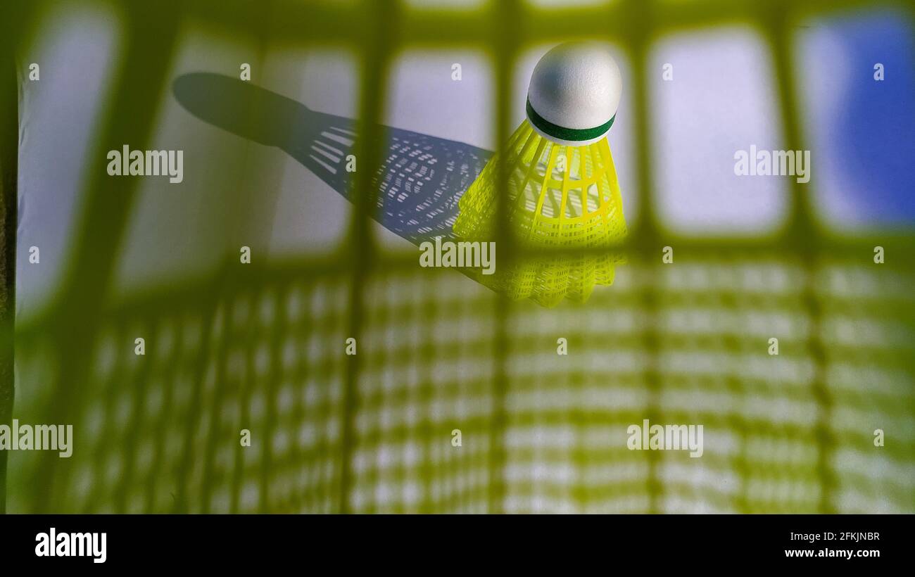 A bright yellow shuttlecock for badminton on a white background Stock ...
