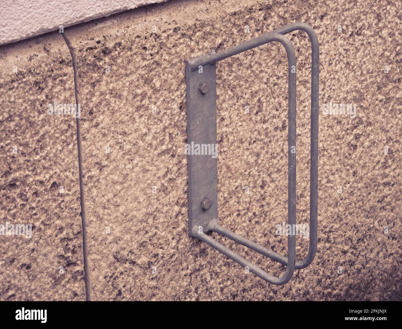 A closeup of a fixed wall-mounted cycle rack Stock Photo - Alamy
