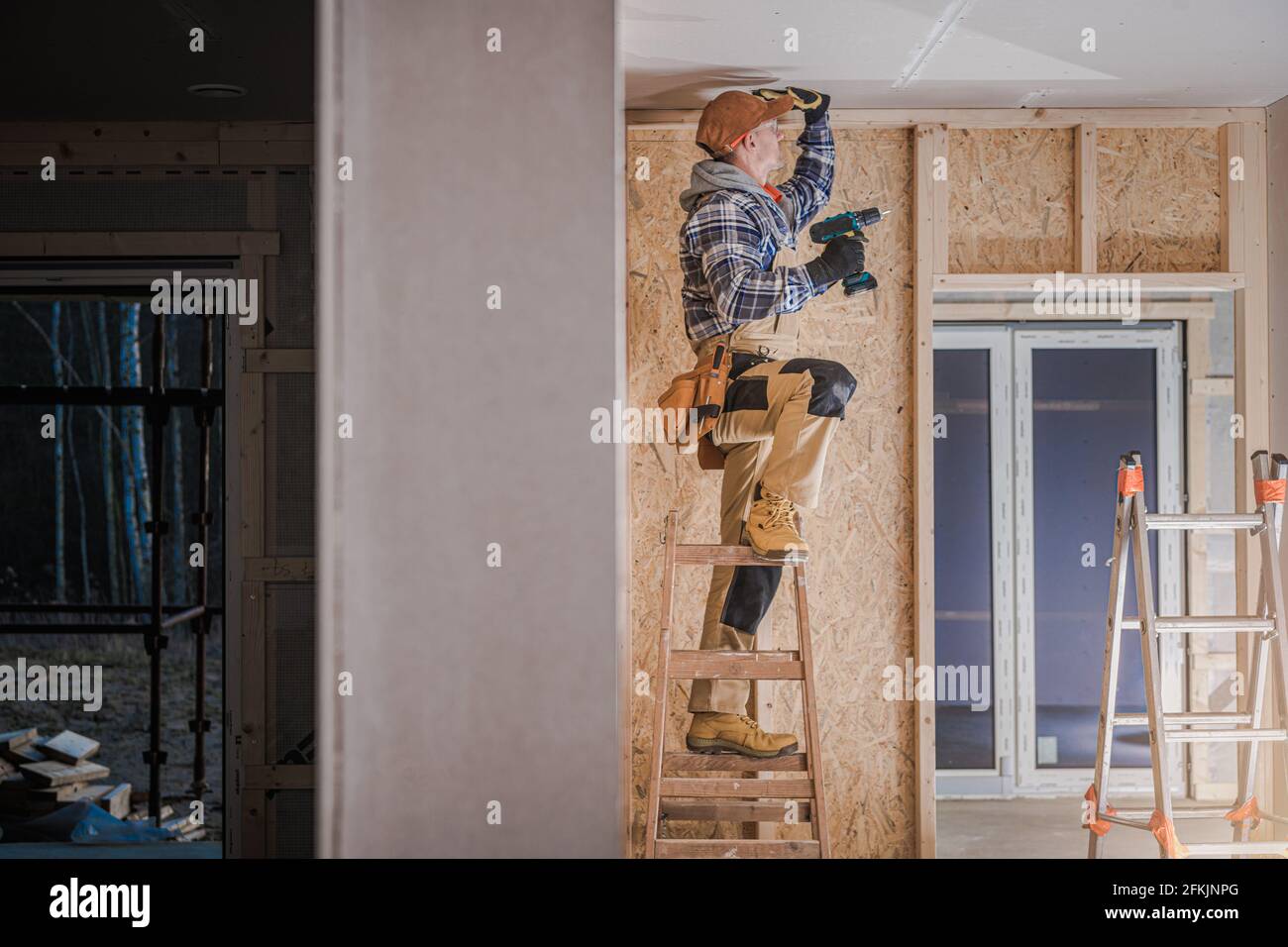 Caucasian Construction Worker In His 40s Installing Drywall Ceiling ...