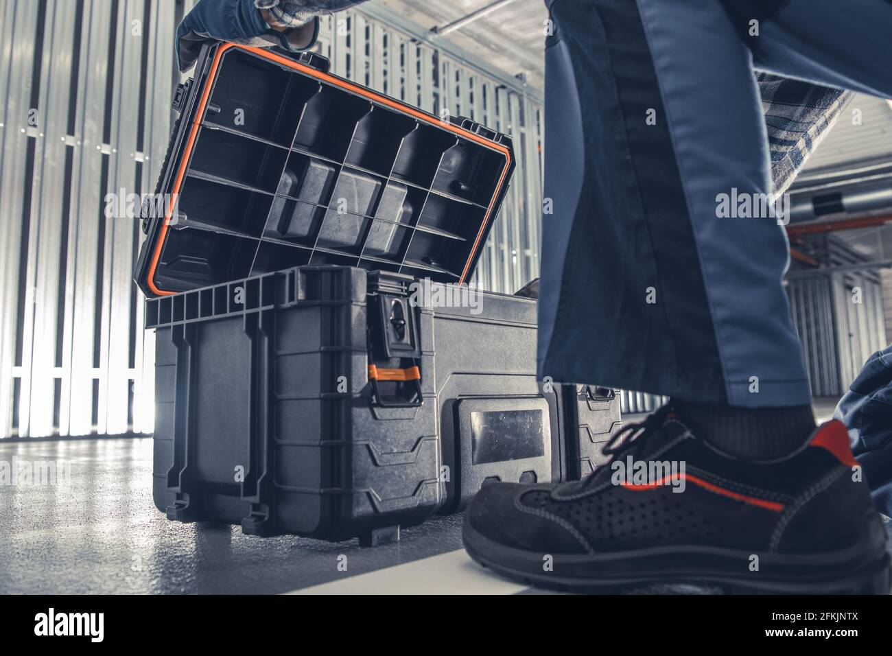 HVAC Worker Opening His Plastic Tools Box Inside Underground Building ...