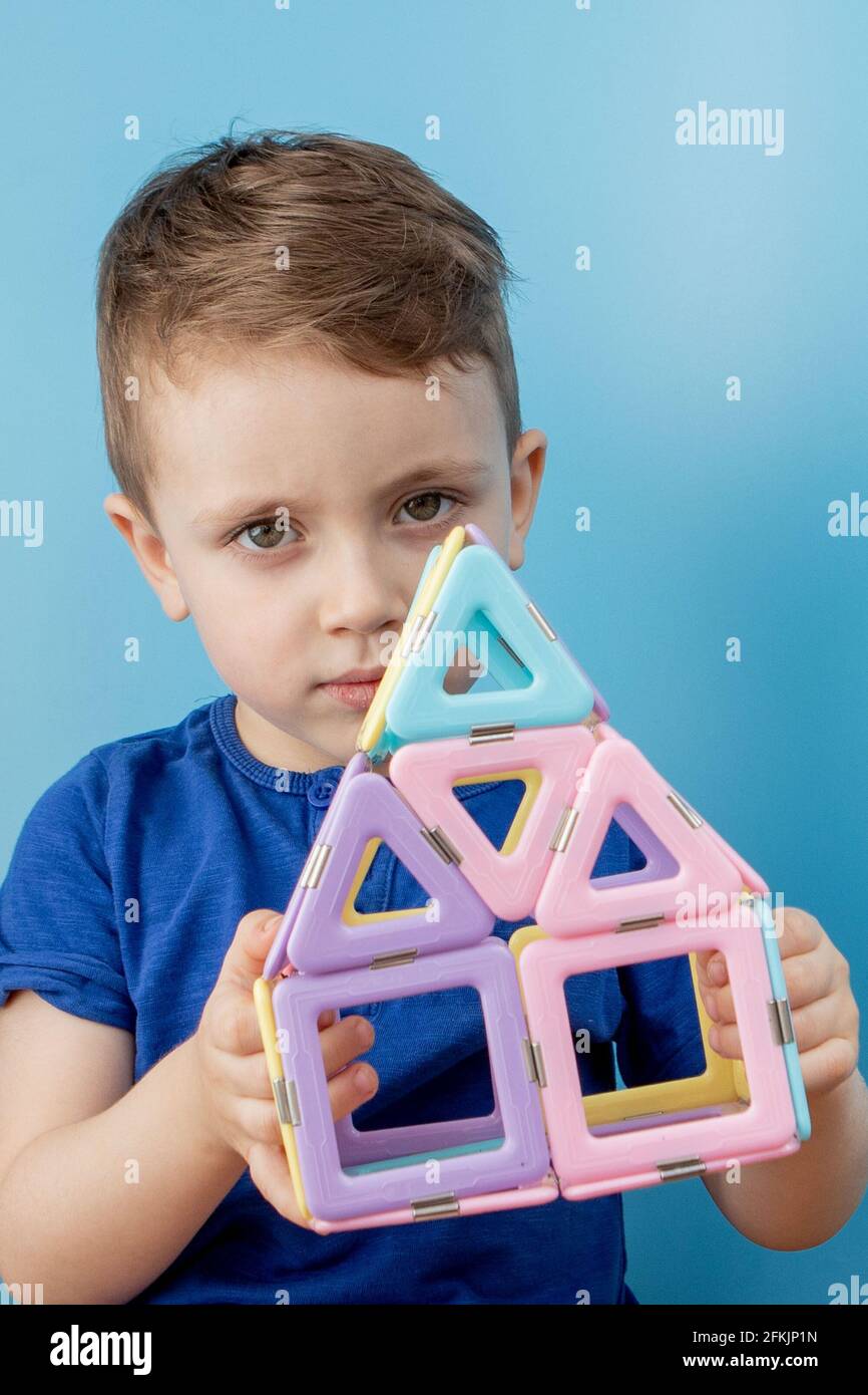 Boy looks through the shape in the color constructor with the ...