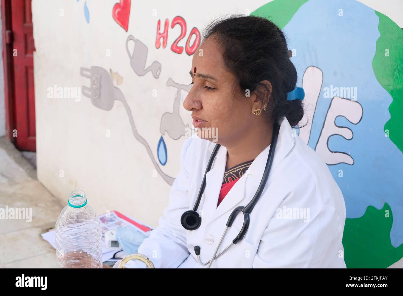 Female doctor drinking water hi-res stock photography and images - Alamy