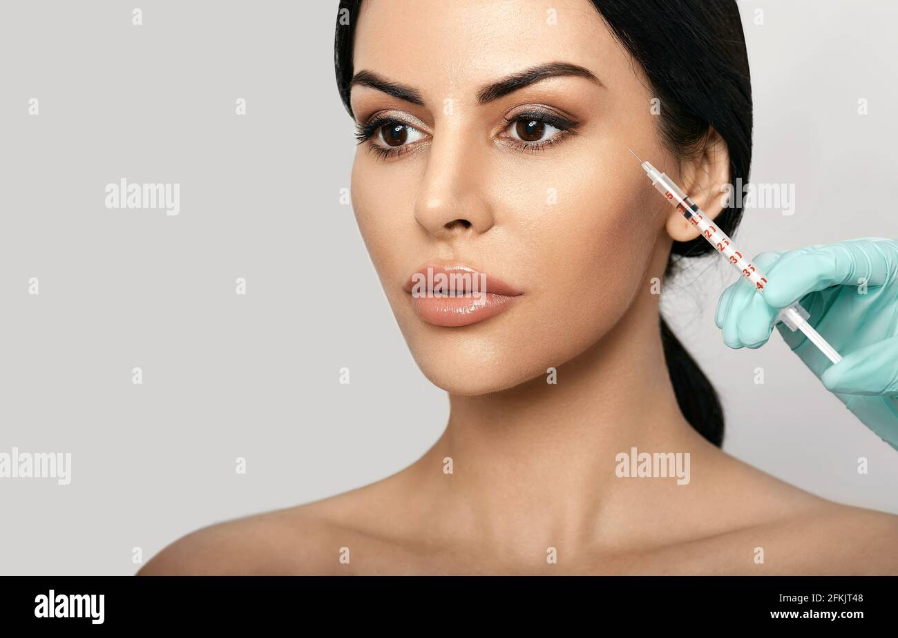 Eye wrinkle injection. Beautiful woman having eye wrinkle injection for ...