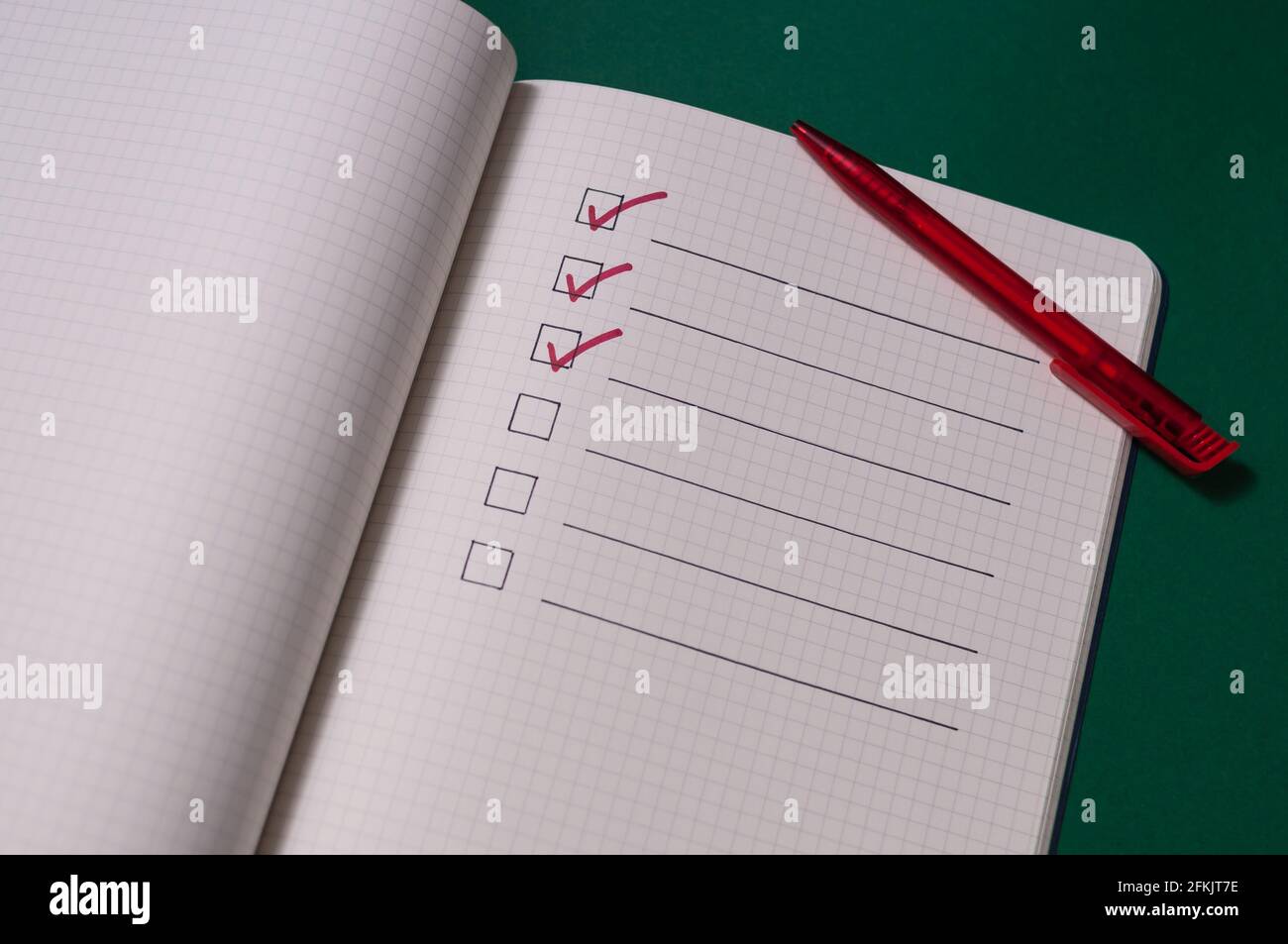 To-do list with several points. Open notebook on green background ...