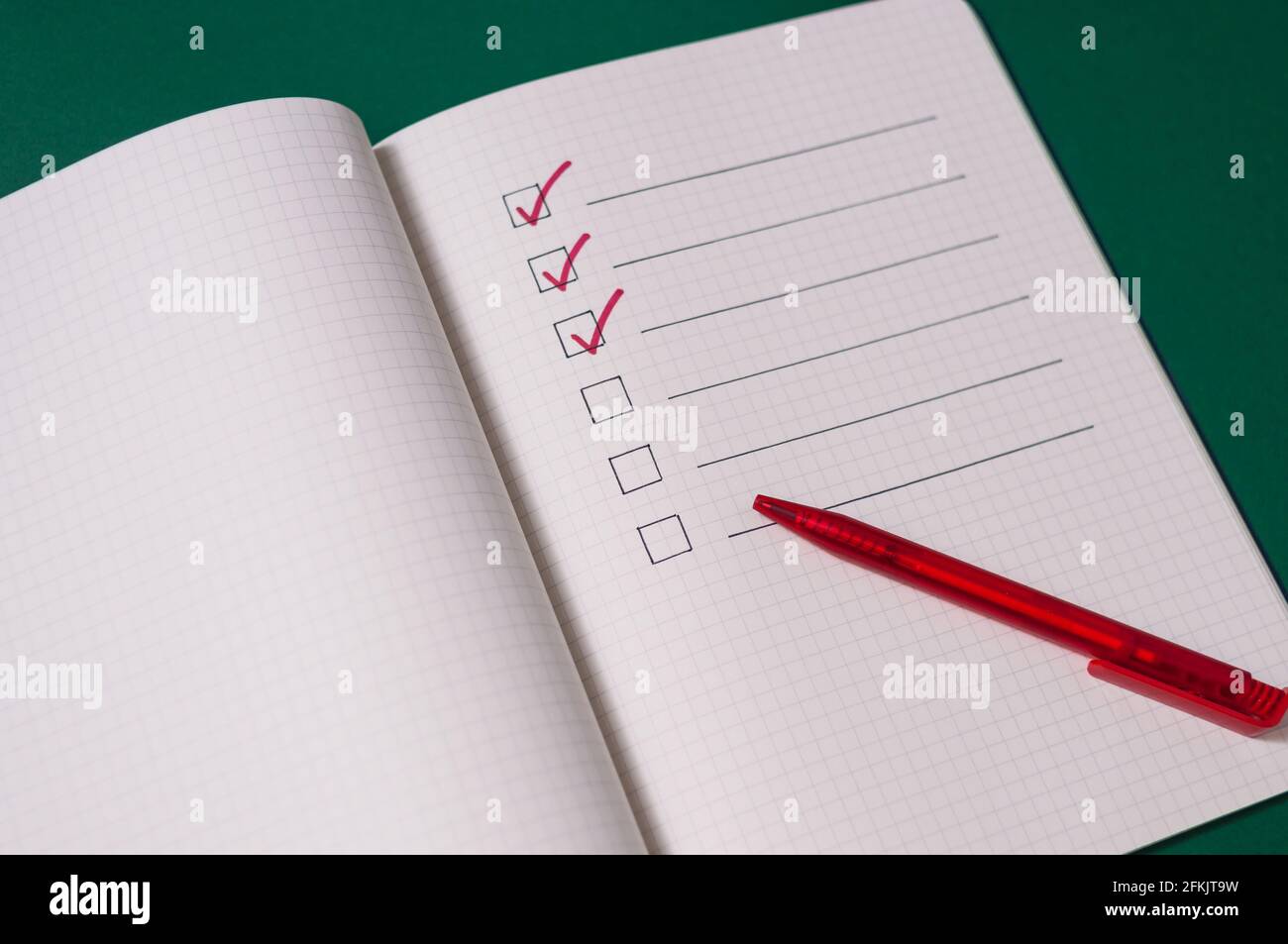 To-do list with several points. Open notebook on green background ...