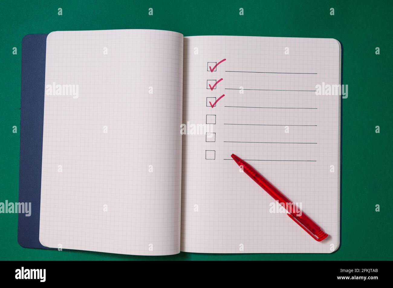 To-do list with several points. Open notebook on green background ...