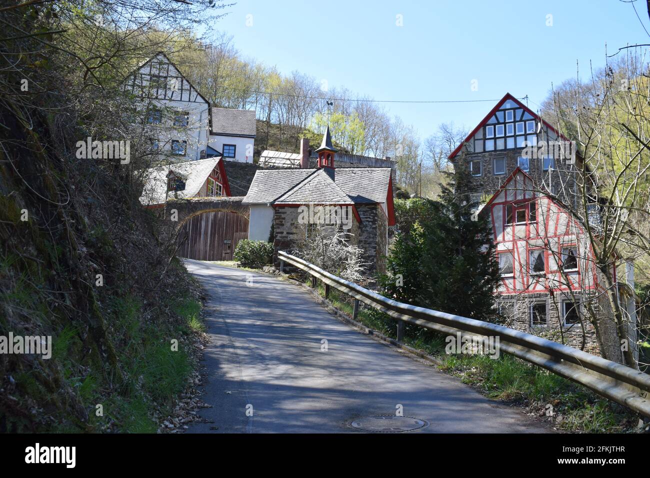 idyllic valley with steep road and old mills Stock Photo - Alamy