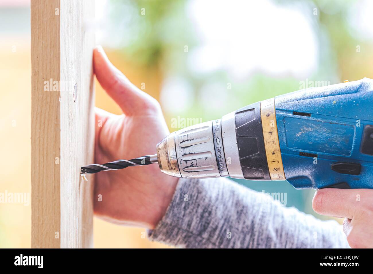 Do it yourself home handyman is using a drill for drilling wood Stock ...