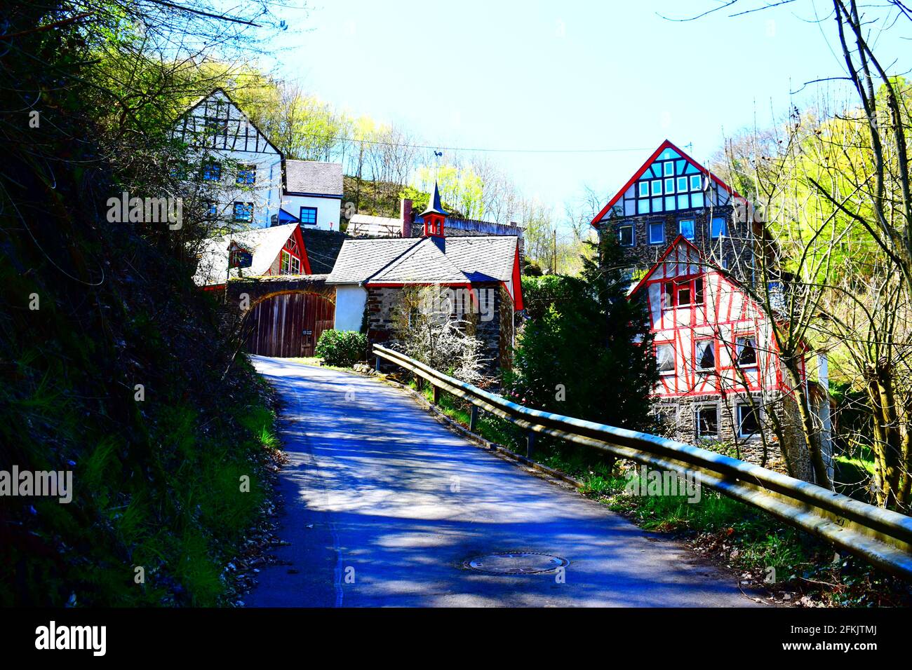 idyllic valley with steep road and old mills Stock Photo - Alamy