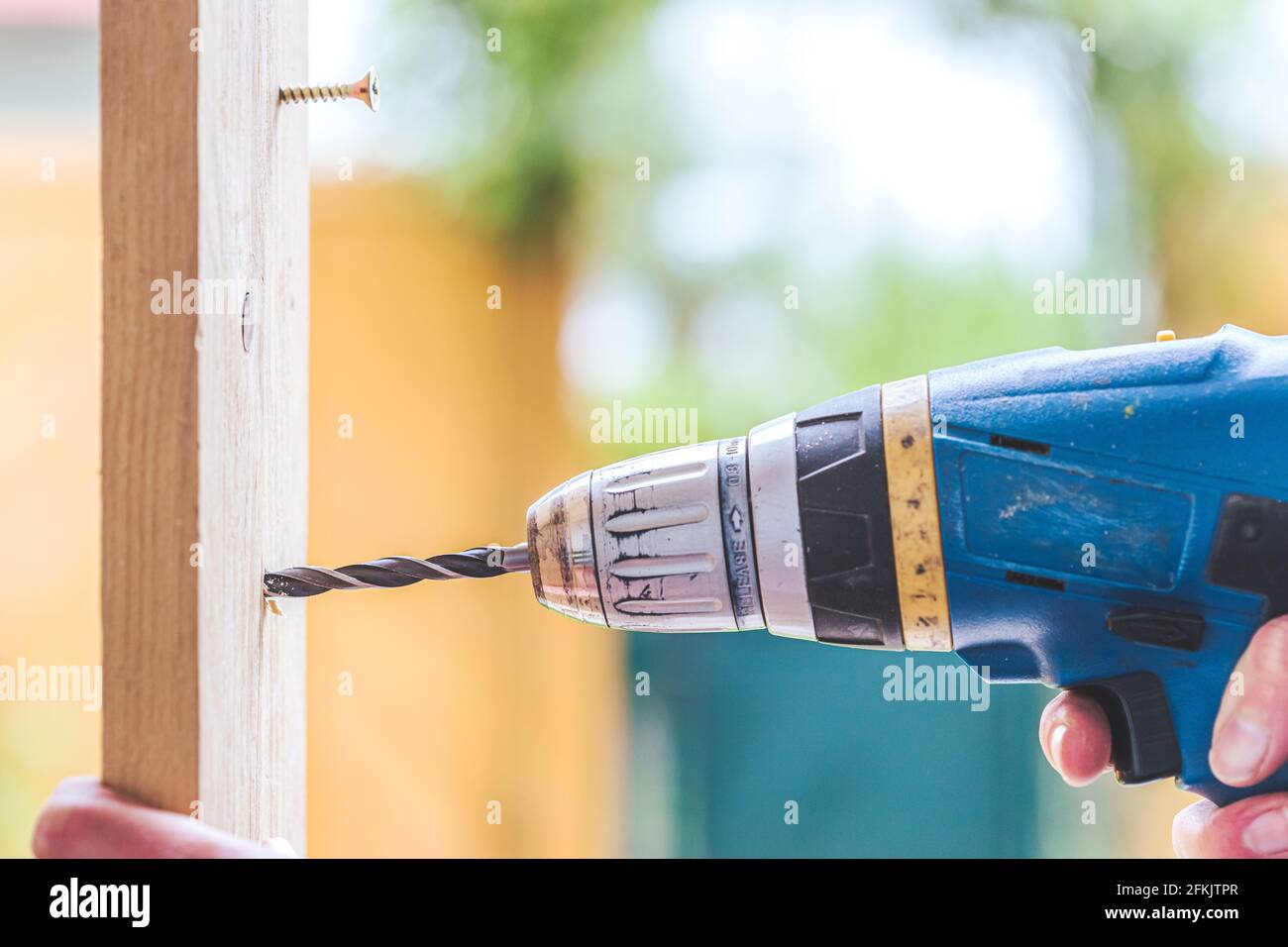 Do it yourself home handyman is using a drill for drilling wood Stock ...