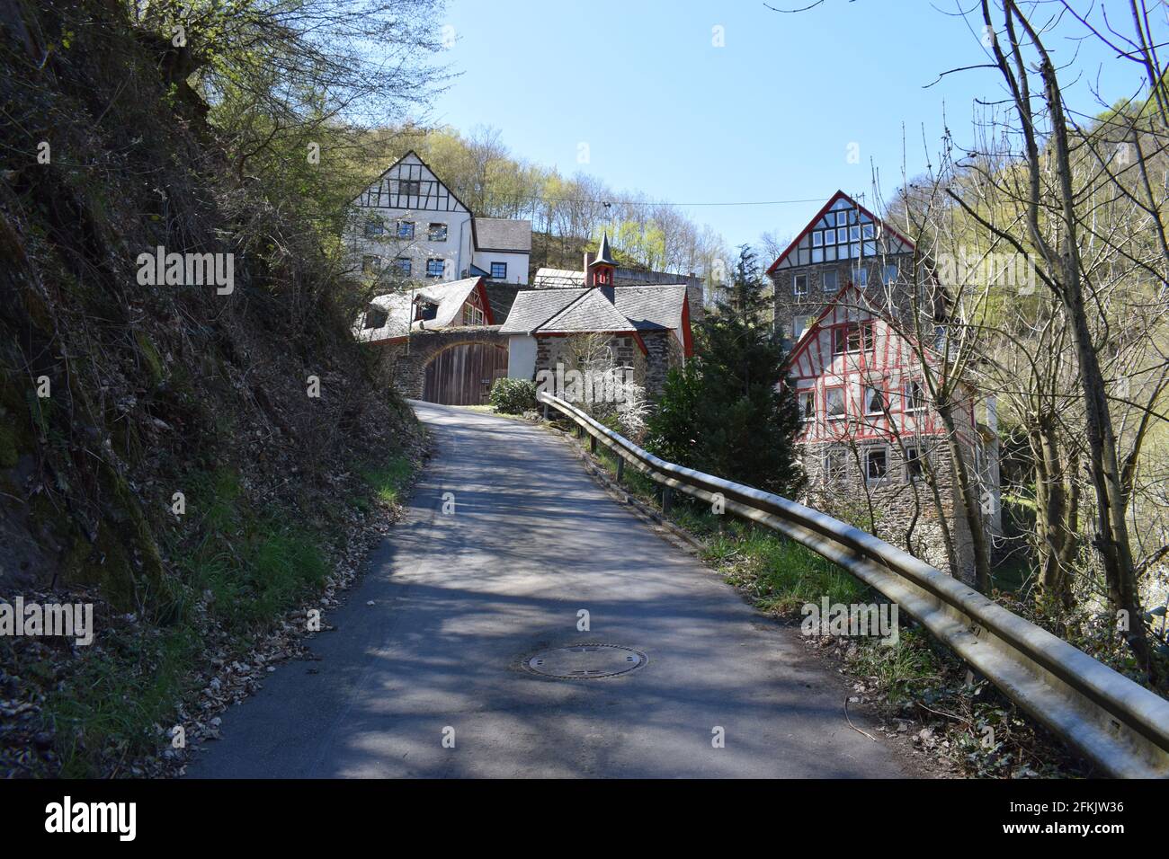 idyllic valley with steep road and old mills Stock Photo - Alamy