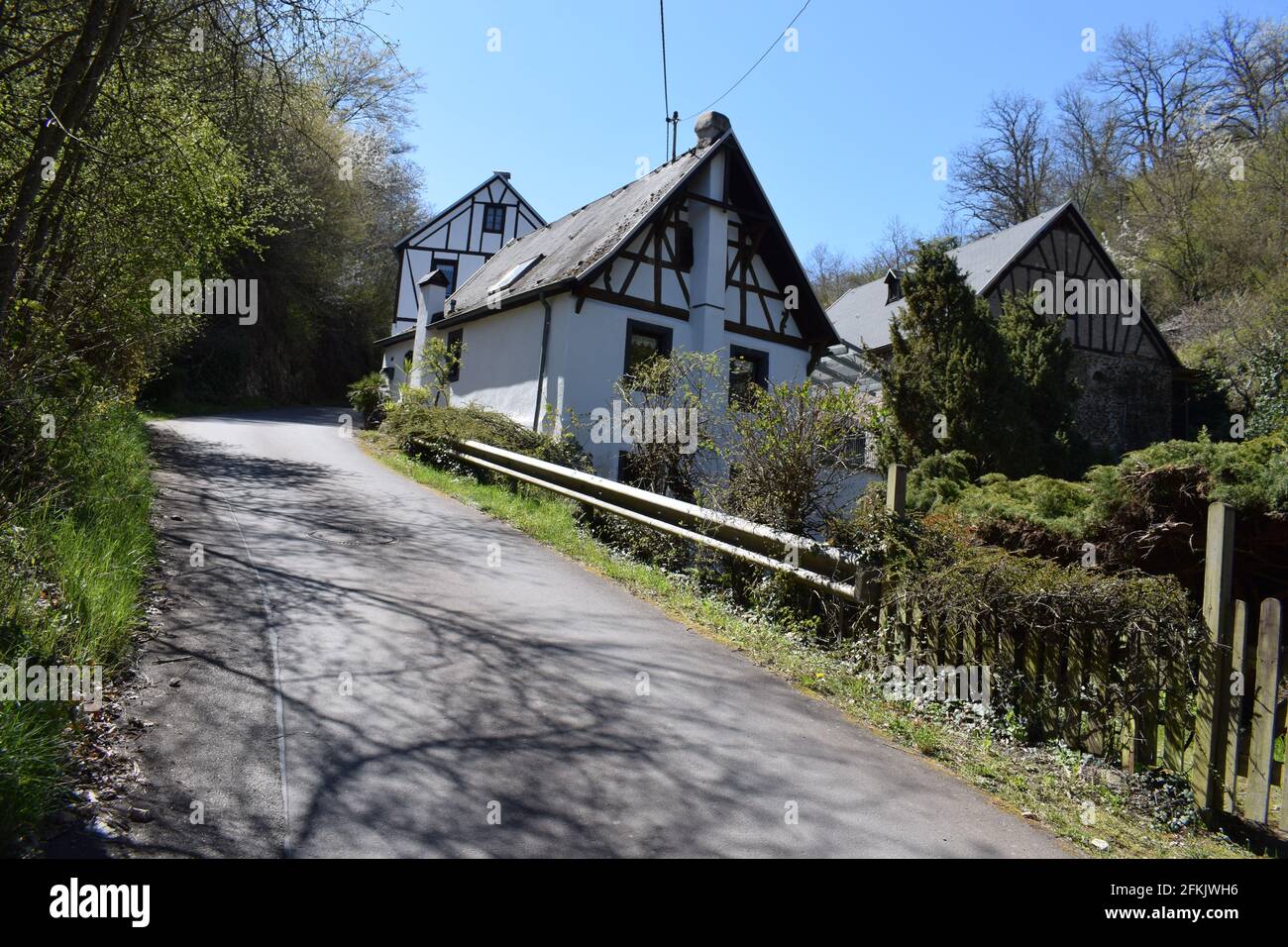 idyllic valley with steep road and old mills Stock Photo - Alamy