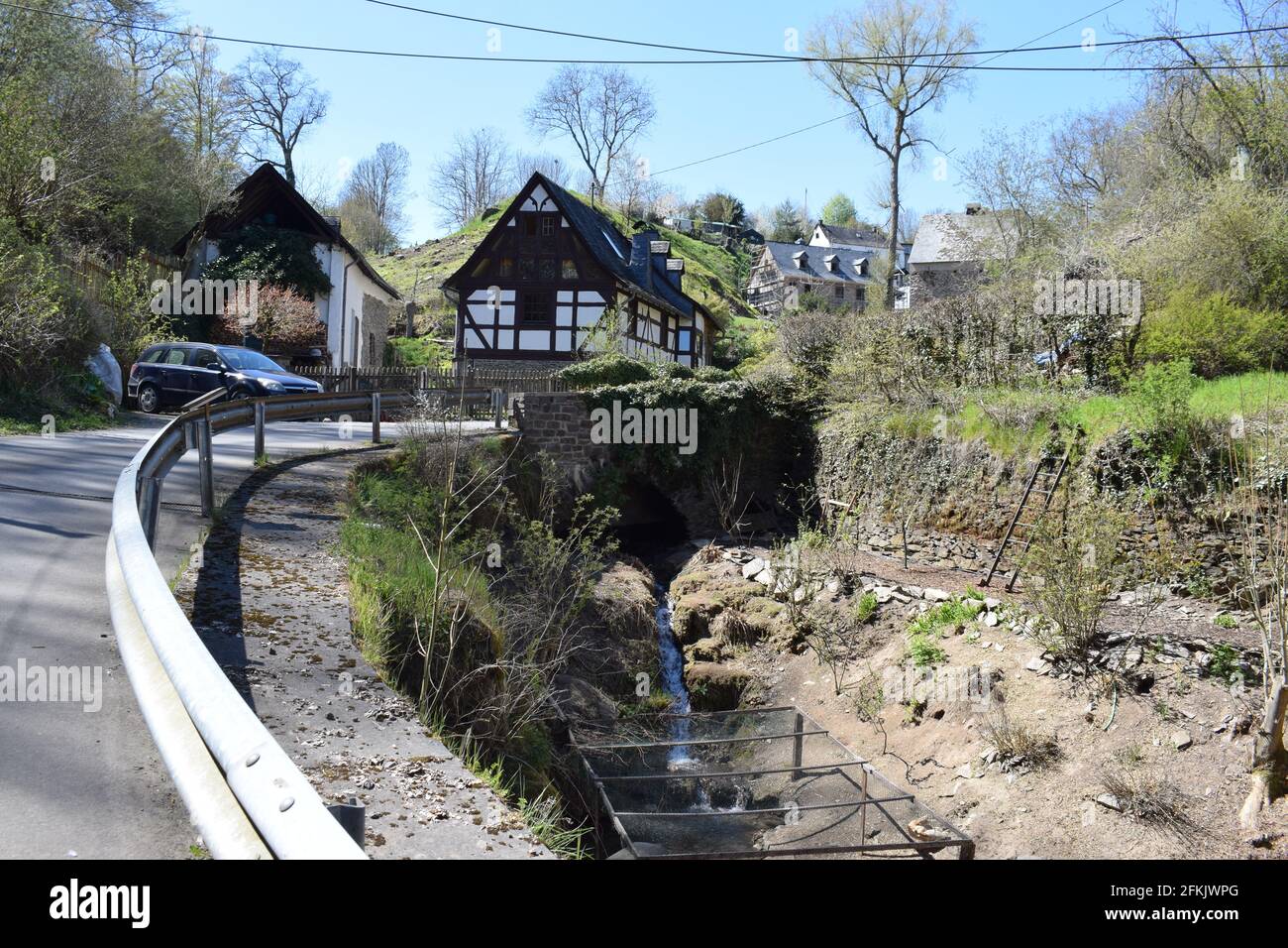 idyllic valley with steep road and old mills Stock Photo - Alamy