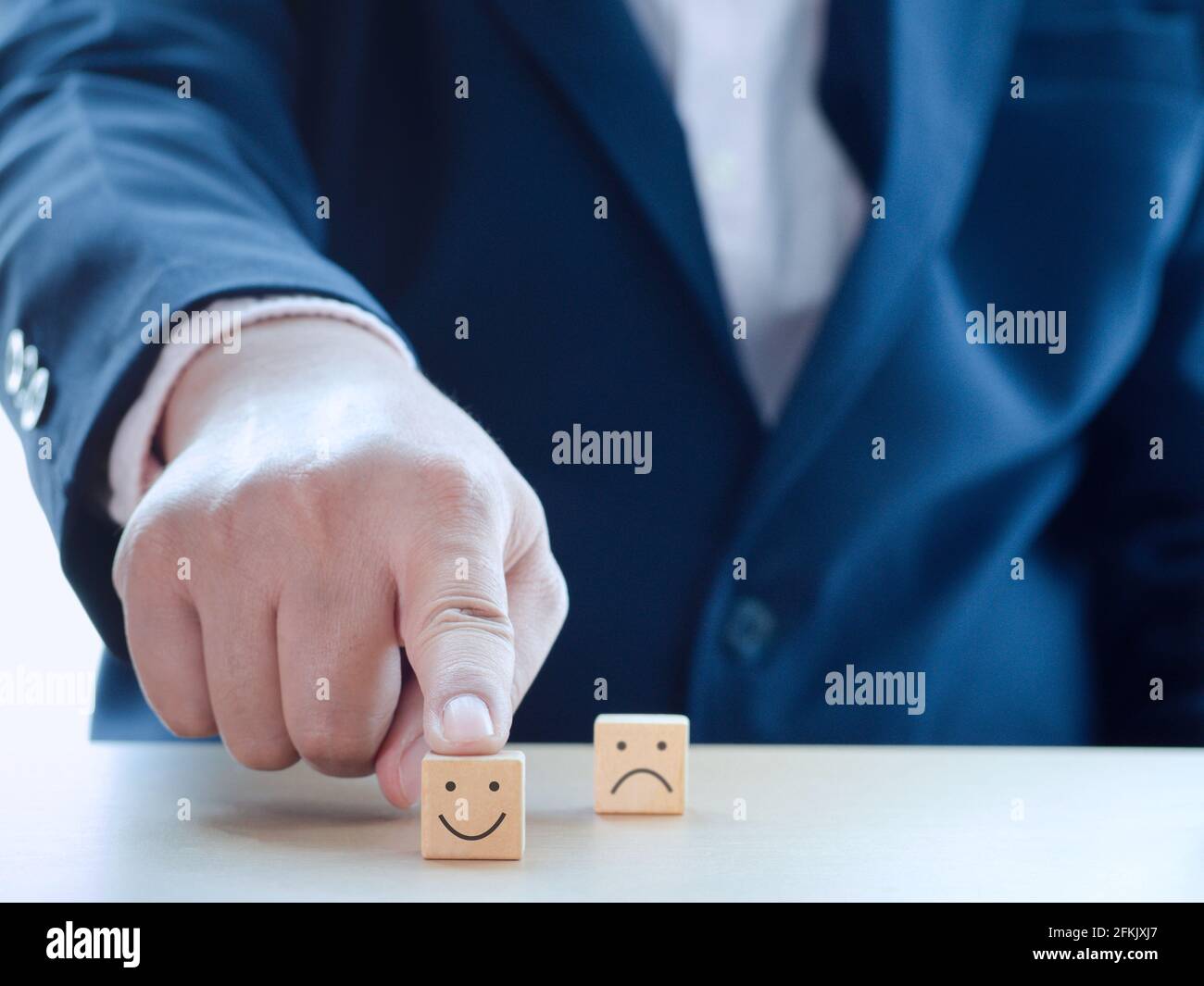 Rating feedback from businessman hand choose smiley face and blurred ...