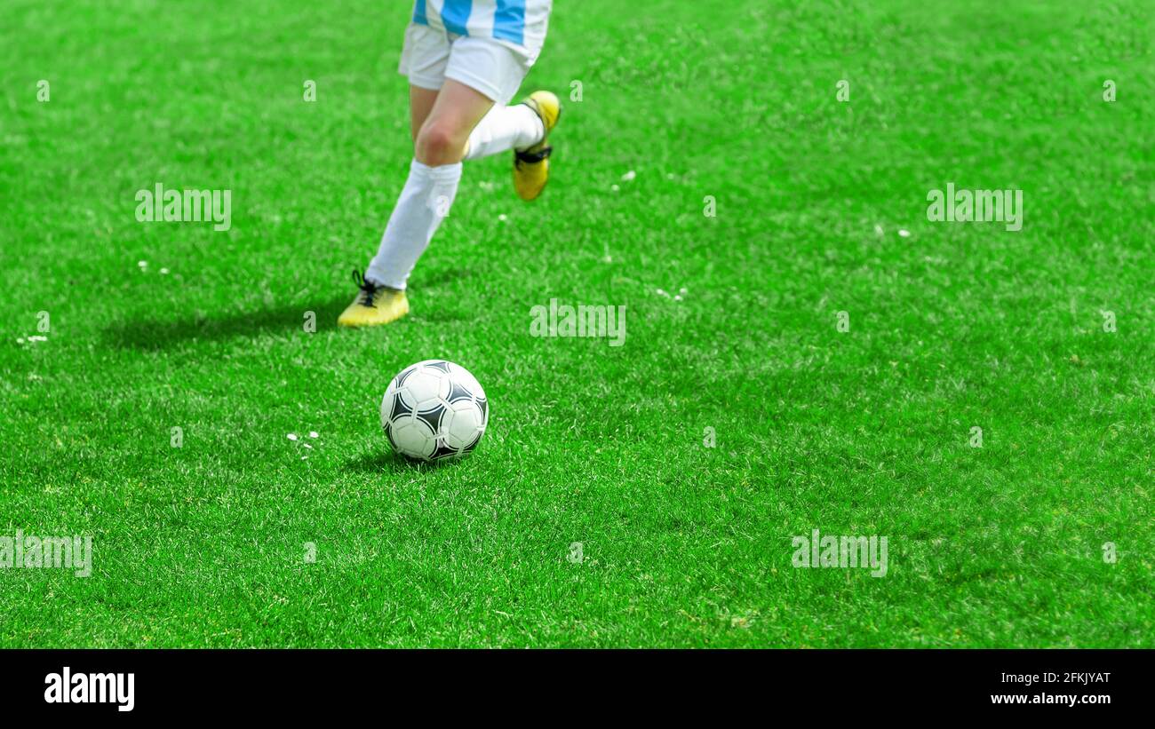 Football Player Compete For a Ball. Children Playing Sports on Grass ...