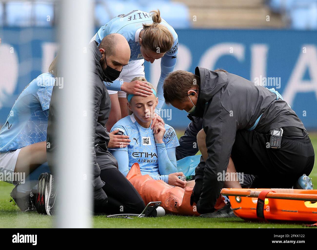 Manchester City's Chloe Kelly receives treatment to a leg injury ...