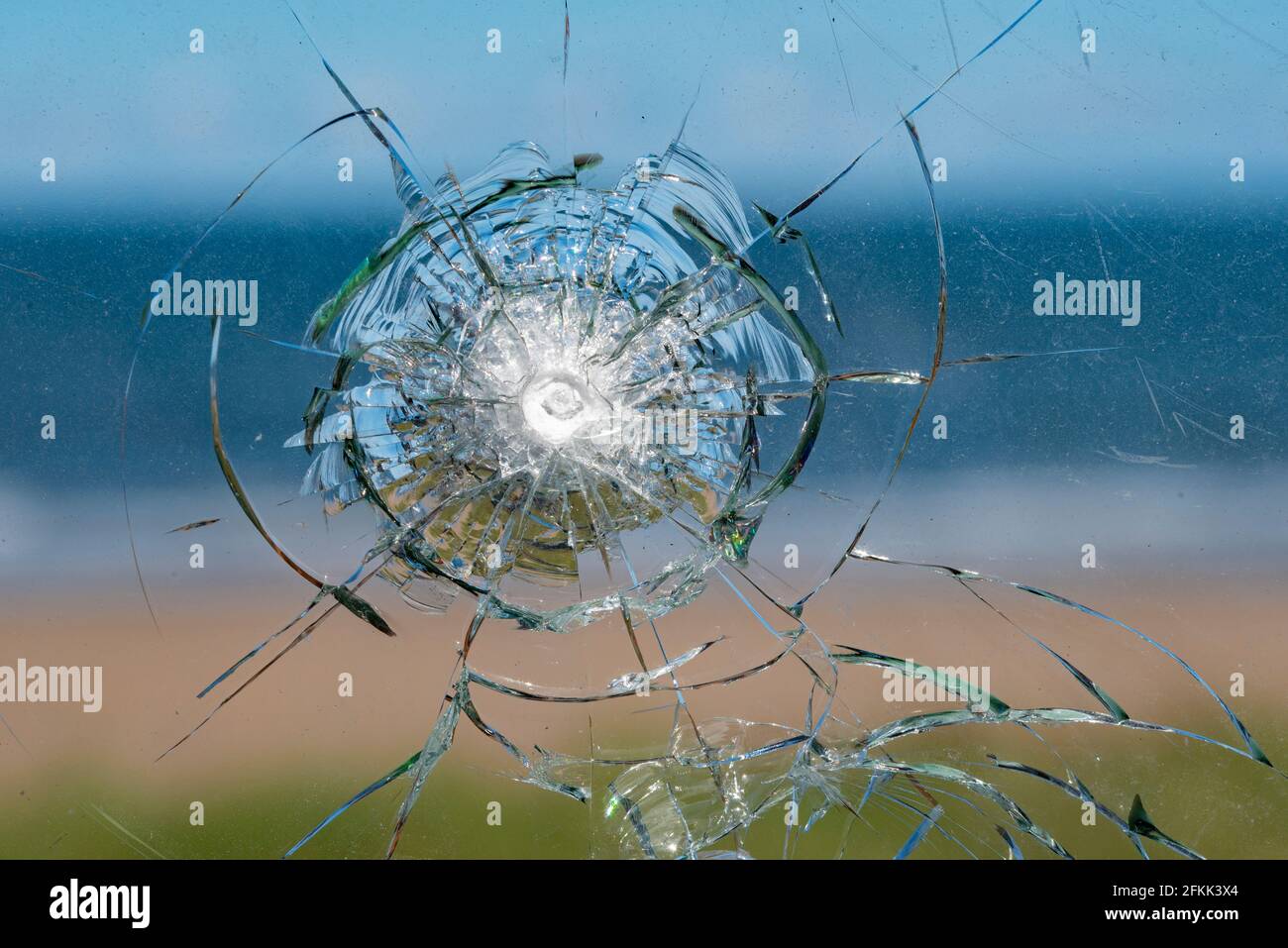 Impact fractures on window Stock Photo - Alamy