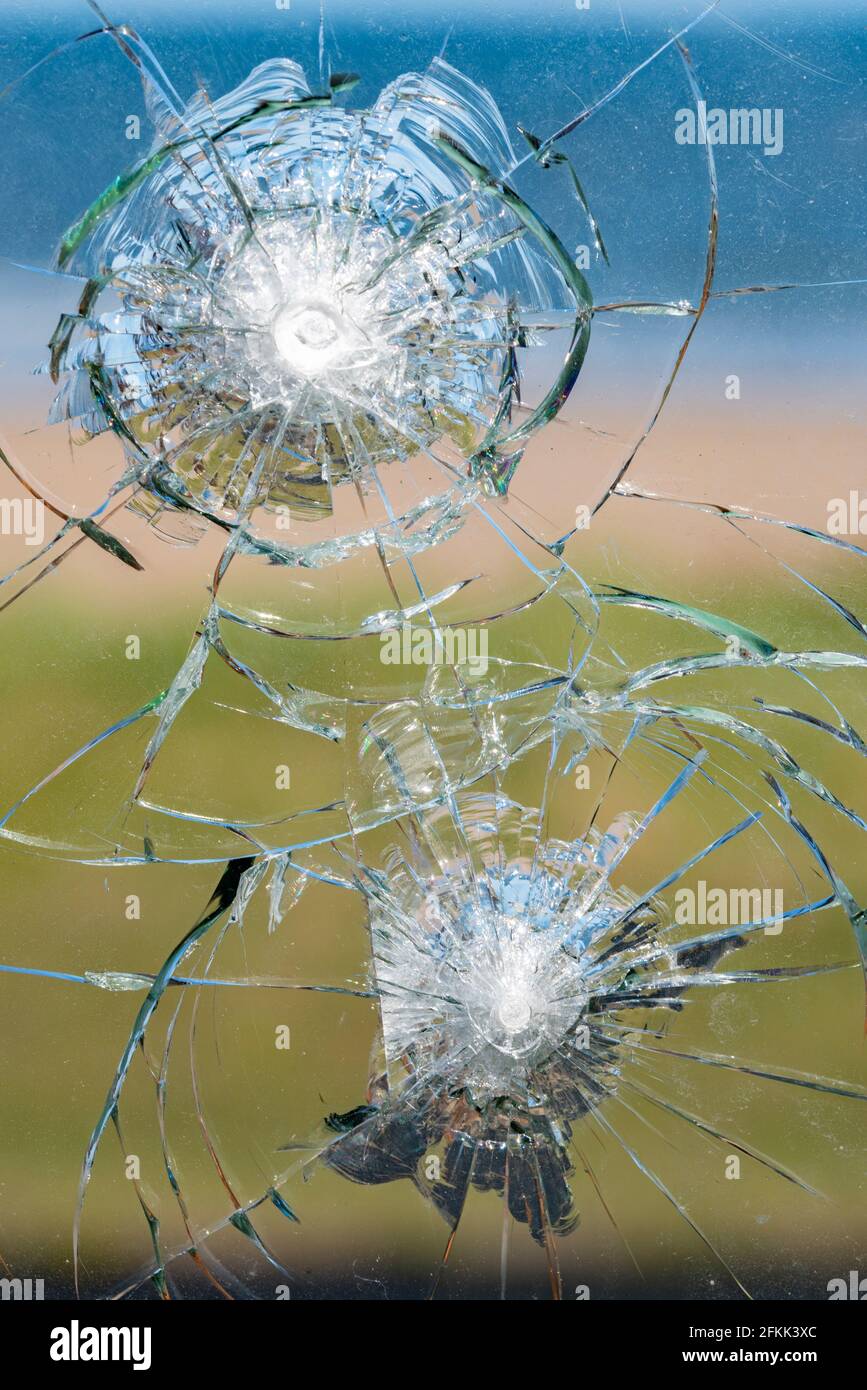 Impact fractures on window Stock Photo - Alamy