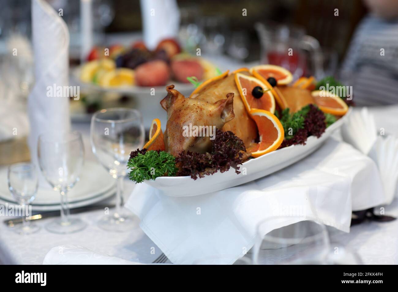 Grilled whole pig on a plate at the restaurant Stock Photo - Alamy