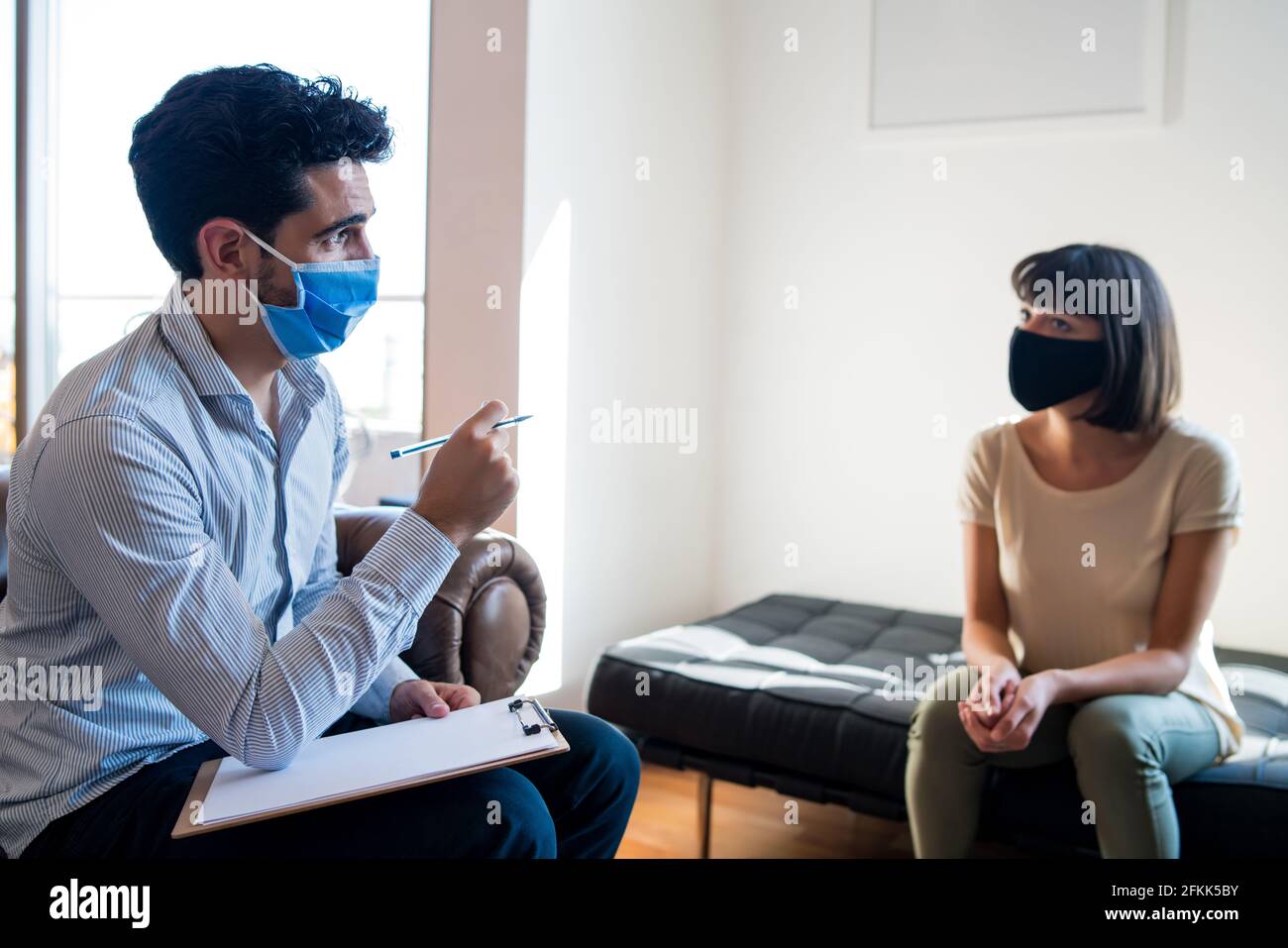 Psychologist talking with patient on therapy session Stock Photo - Alamy