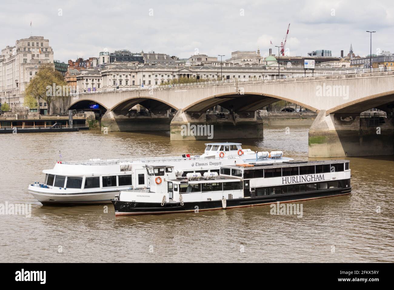 Two river cruisers anchored next to Waterloo Bridge on the River Thames ...