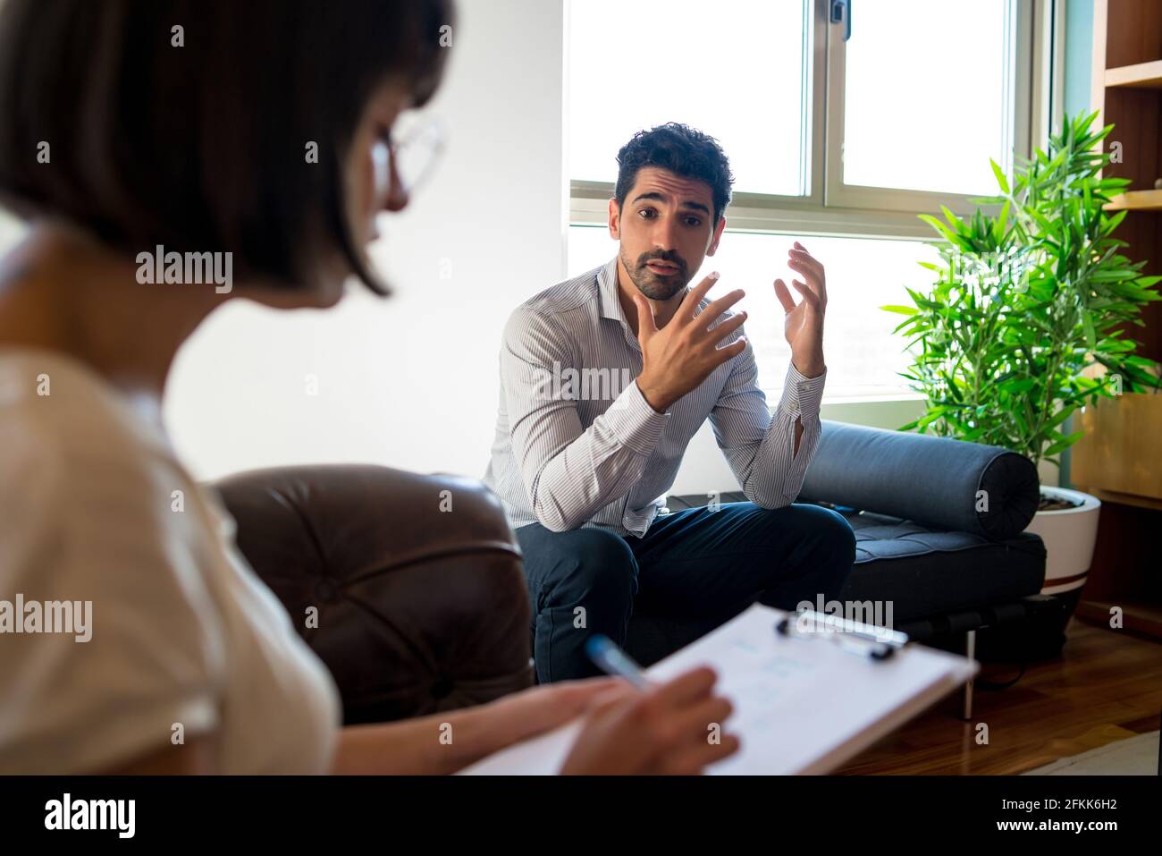 Psychologist taking notes during therapy session Stock Photo - Alamy