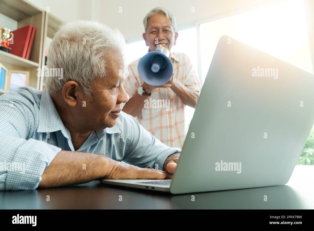 Old Asian elderly yell to a megaphone to talk with a friend for ...