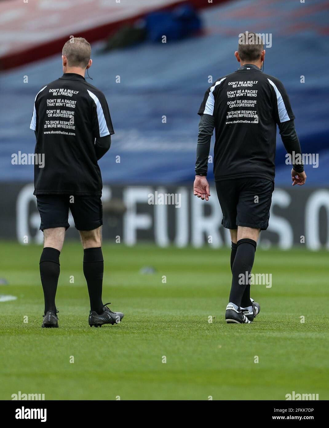 Referee David Coote (right) warm up whilst wearing warm up t-shirt ...