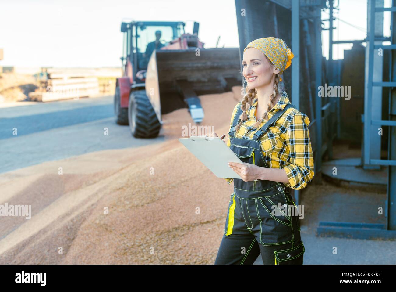 Grain being stored in granary or storage house with farmer keeping ...