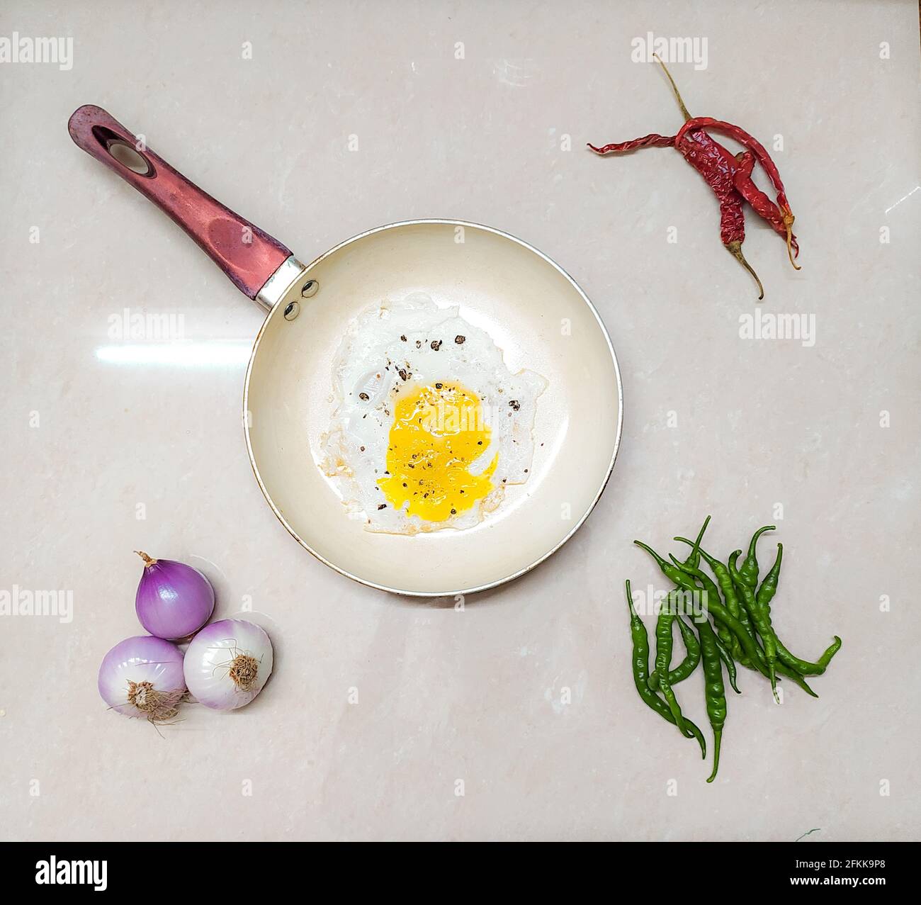 A top view of tasty scrambled eggs with spices and green peppers in a ...