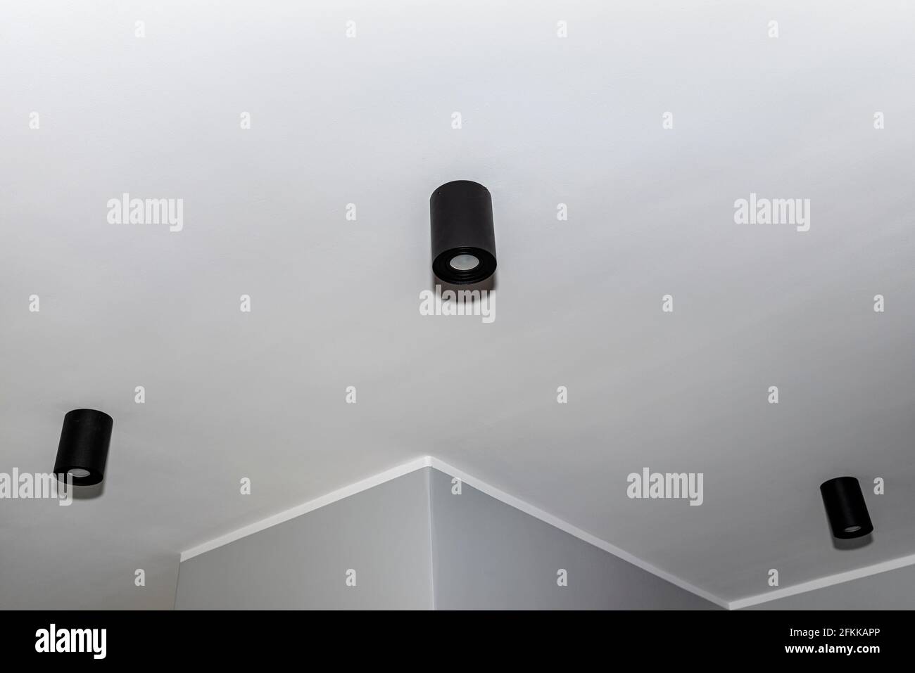 Modern LED lighting in the shape of a tube, covered with matt black ...