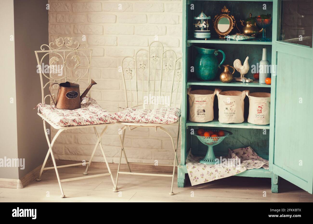 Sideboard and chairs are on a brick background. Vintage style store ...